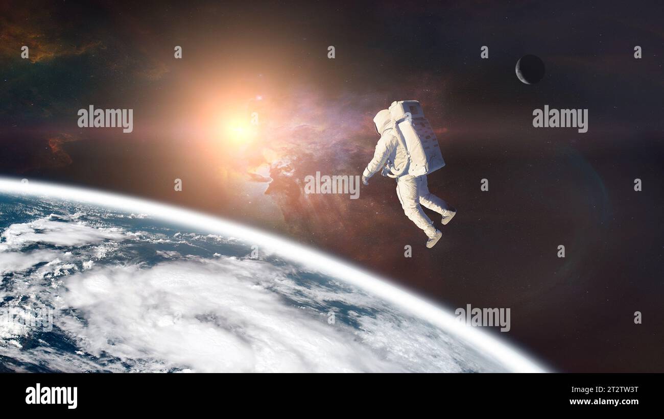 Spaceman on low-orbit of Earth planet with sun light. Elements of this ...