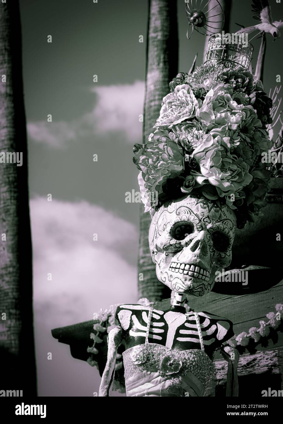 A Day of the Dead lady stands under palm trees at Old Town in San Diego ...