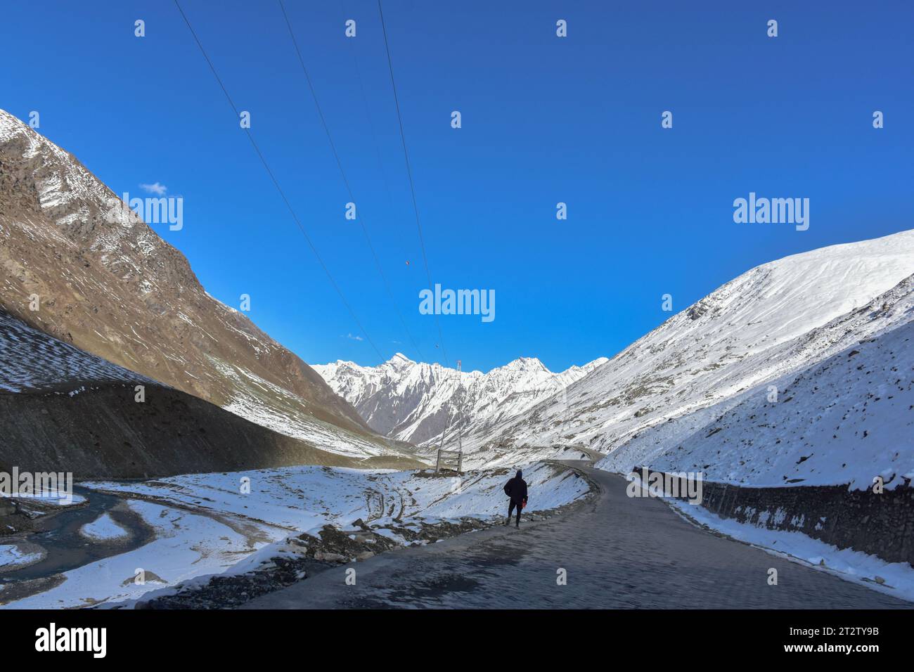 A man walks along the road in Drass, a second coldest place of the ...