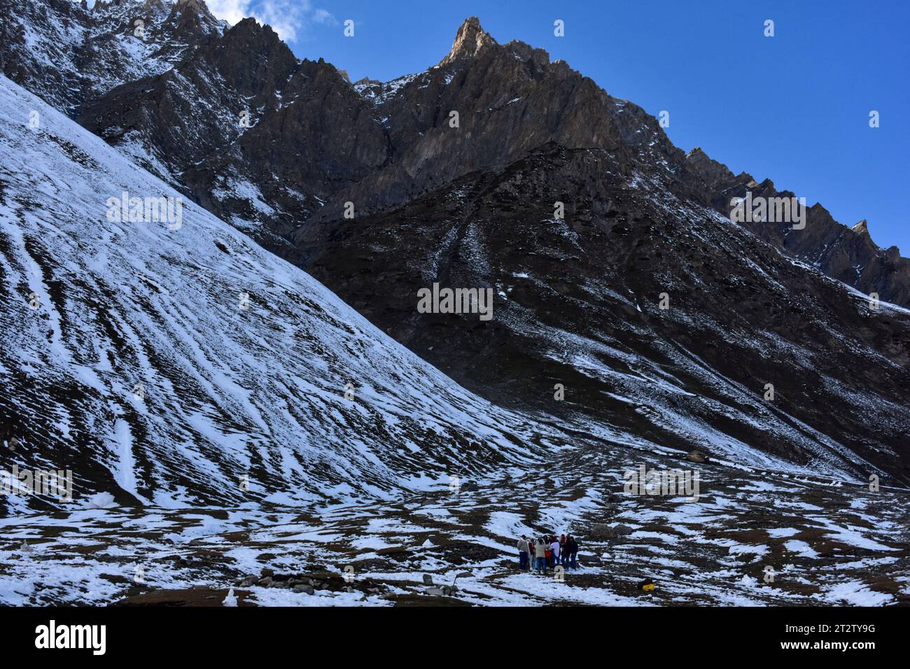 Indian tourists walk through the snow covered hill in Drass, a second ...