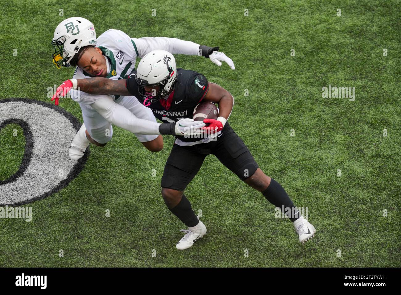 Cincinnati Bearcats running back Corey Kiner, right, carries the ball ...