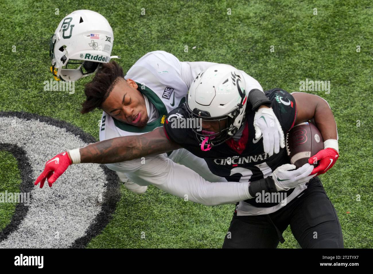 Cincinnati Bearcats running back Corey Kiner, right, carries the ball ...