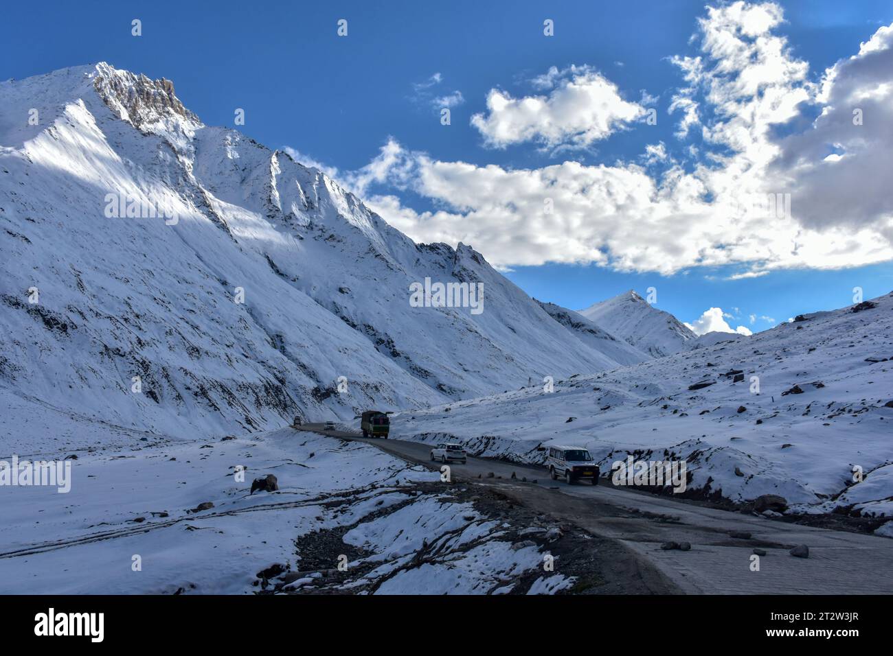 Vehicle moves along the snow covered mountains in Drass, a second ...