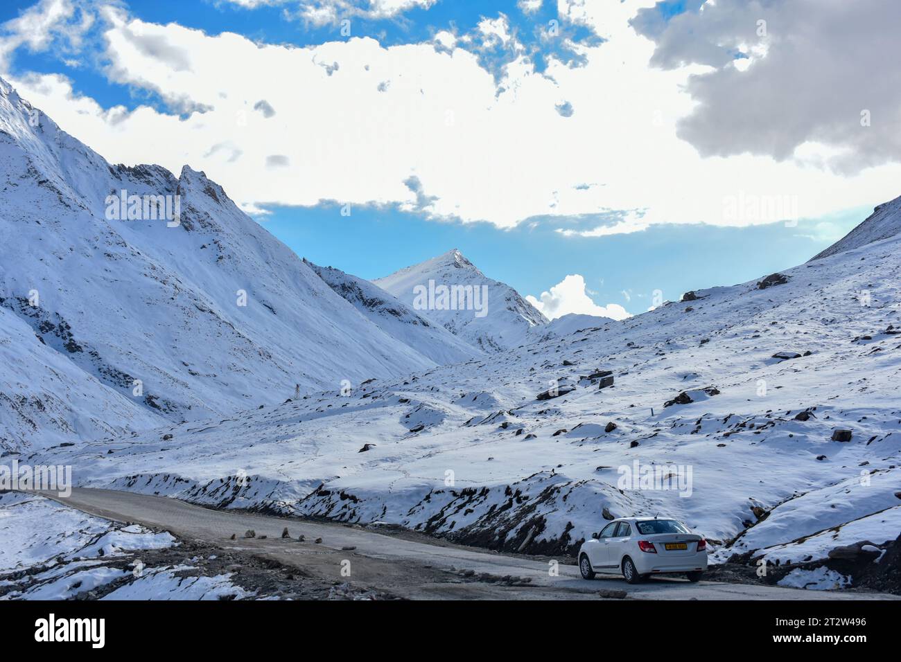A vehicle moves along the snow covered mountains in Drass, a second ...