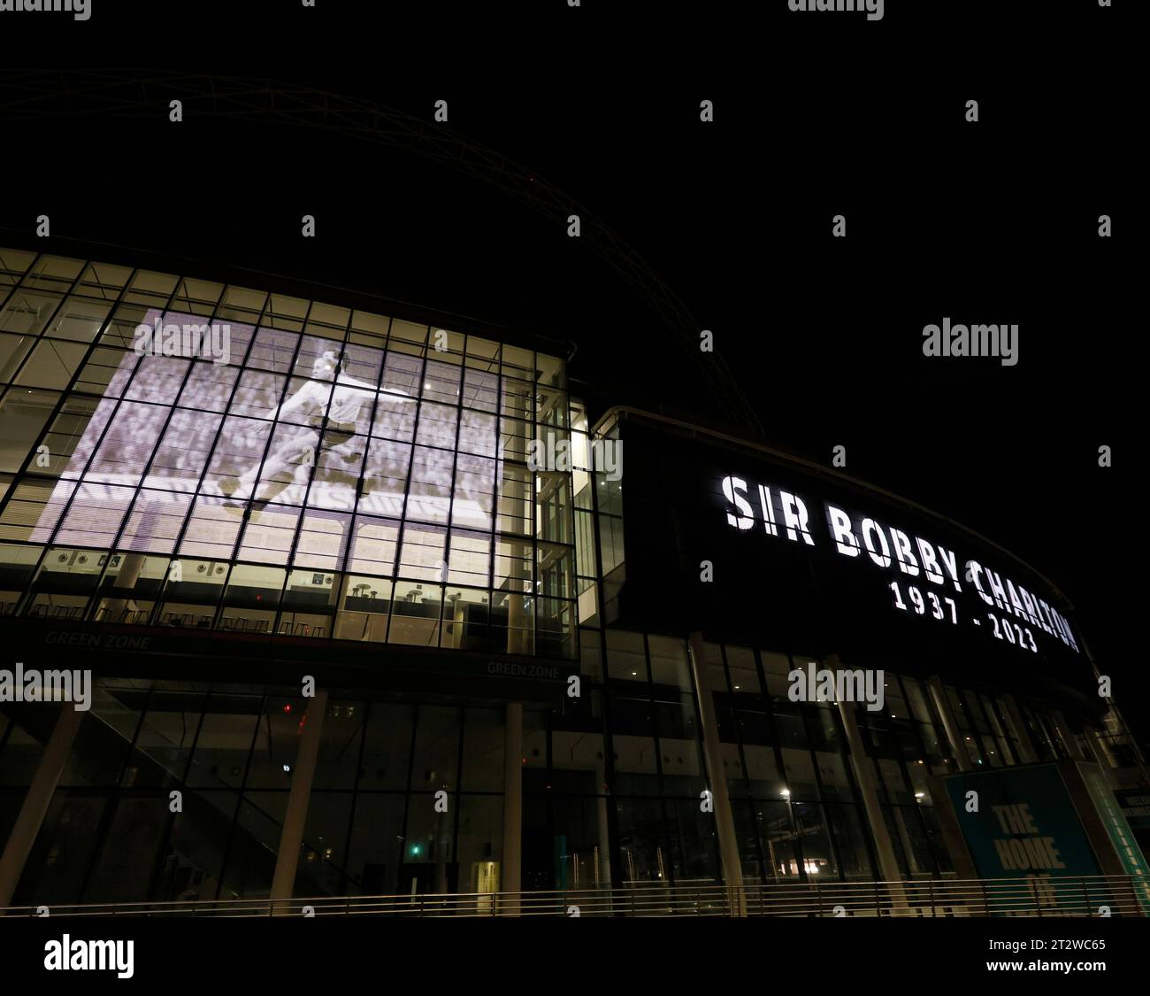A tribute to Sir Bobby Charlton is displayed on giant screens outside ...