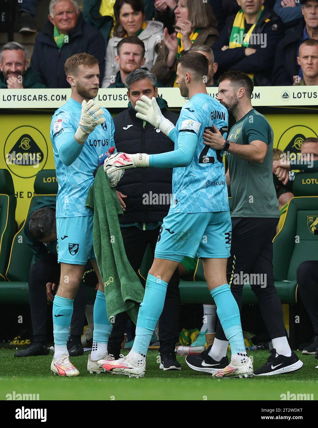 The injured Norwich City goalkeeper Angus Gunn (right) is substituted ...