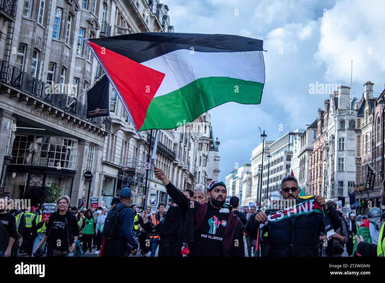 A protestor marches with a large Palestinian flag during the National ...