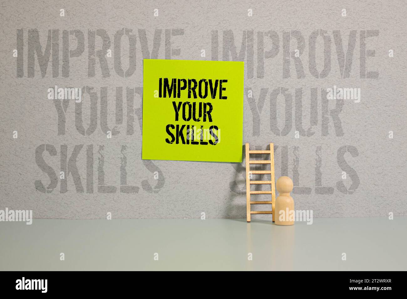 Text IMPROVE YOUR SKILLS on white paper sheet and brown paper notepad ...