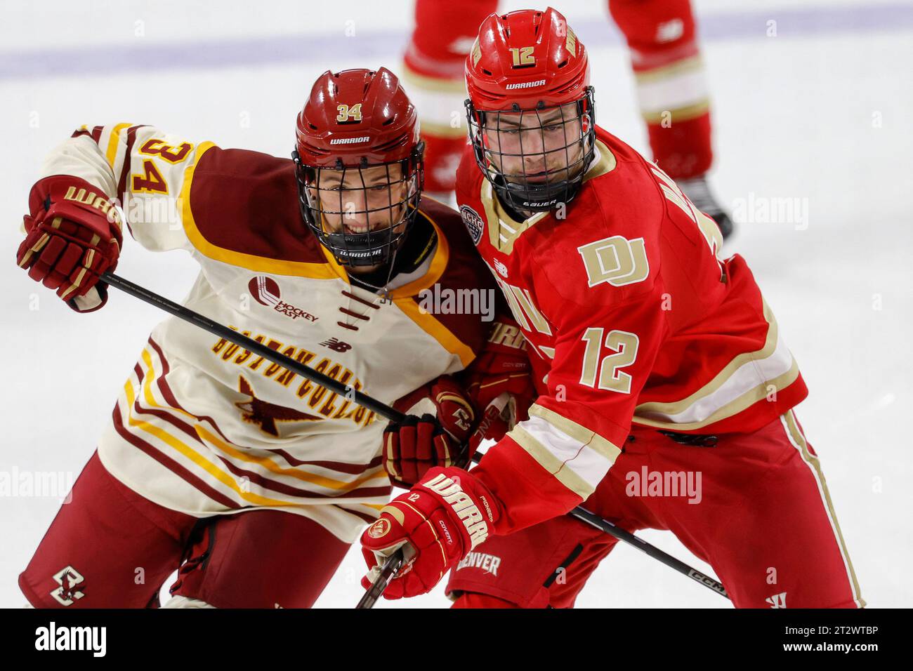 Boston College forward Gabe Perreault (34) battles with Denver forward ...