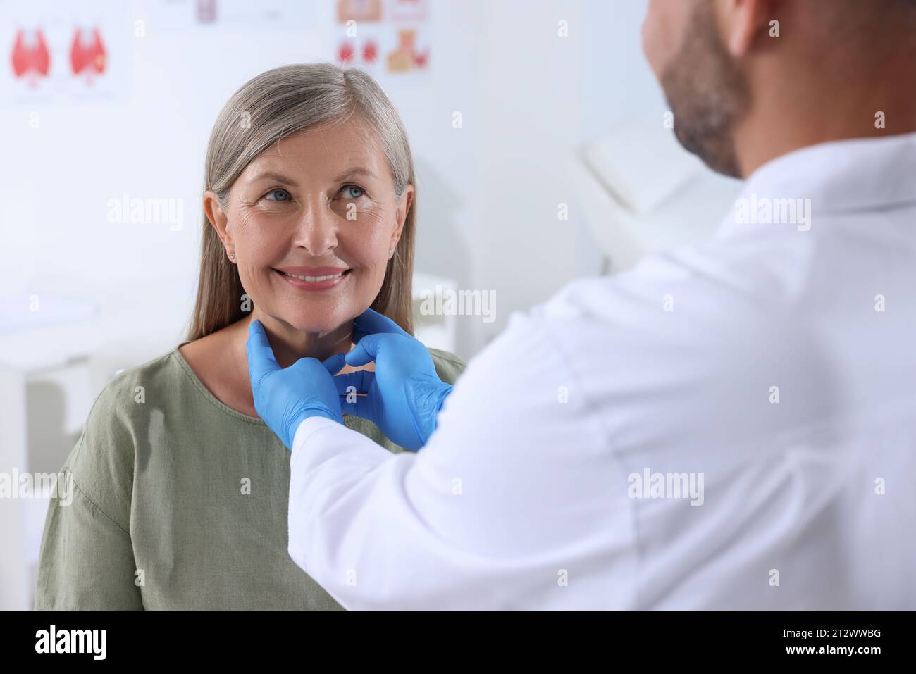 Endocrinologist examining thyroid gland of patient at hospital, closeup ...