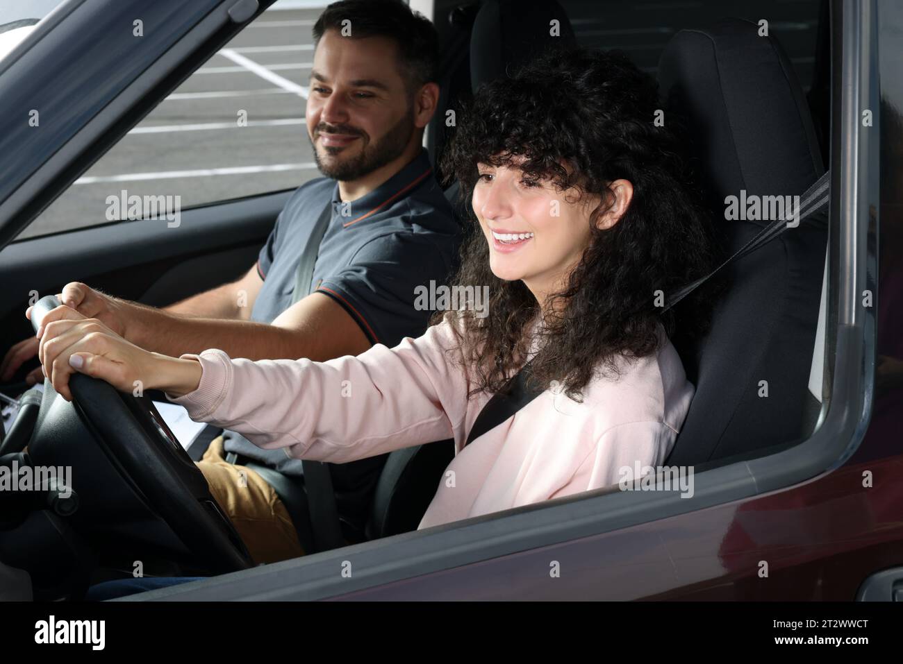 Driving school. Happy student passing driving test with examiner in car ...