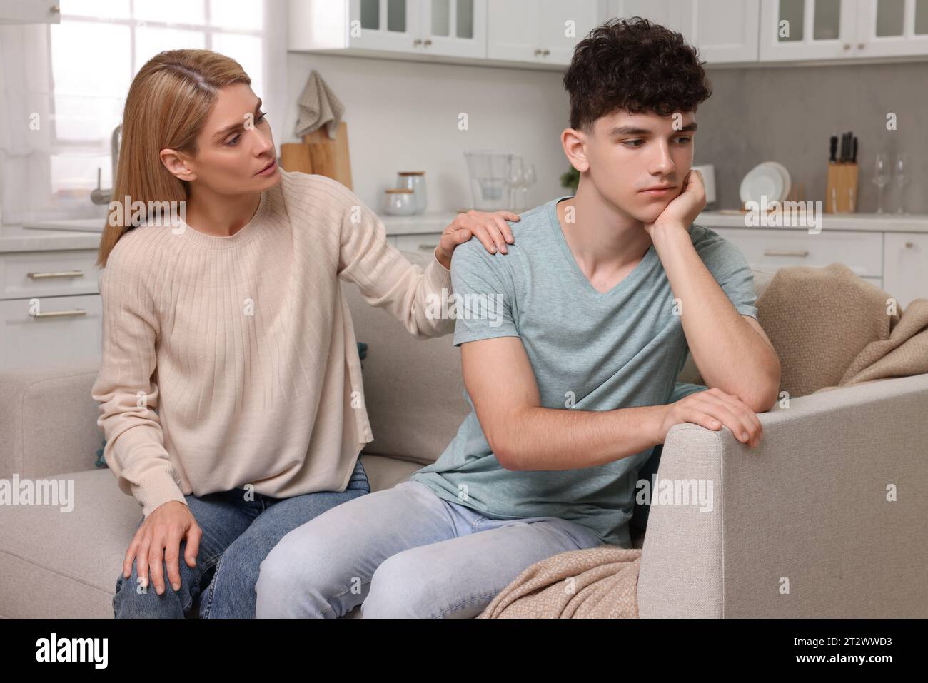 Mother consoling her upset son at home. Teenager problems Stock Photo ...
