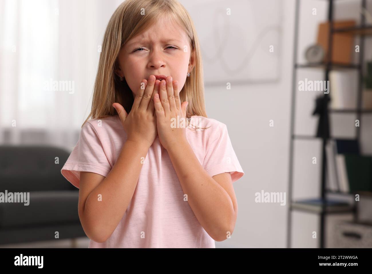 Suffering from allergy. Little girl sneezing at home Stock Photo - Alamy