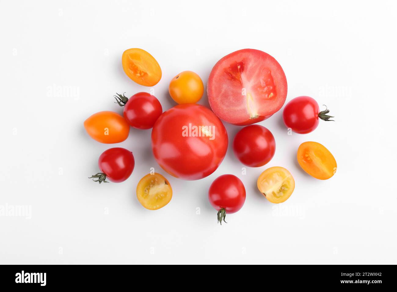 Flat lay composition with different whole and cut tomatoes on white ...