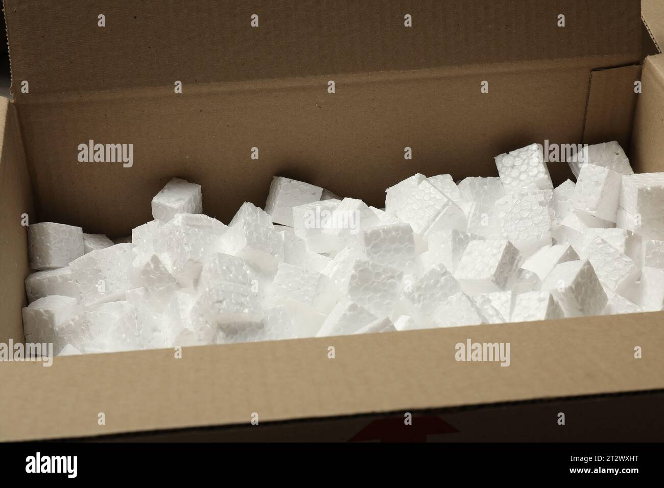 Open cardboard box with pieces of polystyrene foam, closeup. Packaging ...