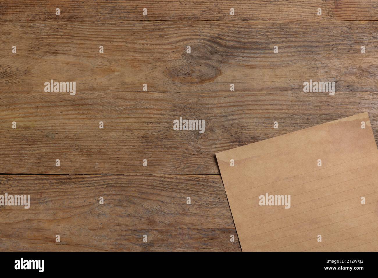 Sheet of old parchment paper on wooden table, top view. Space for text ...