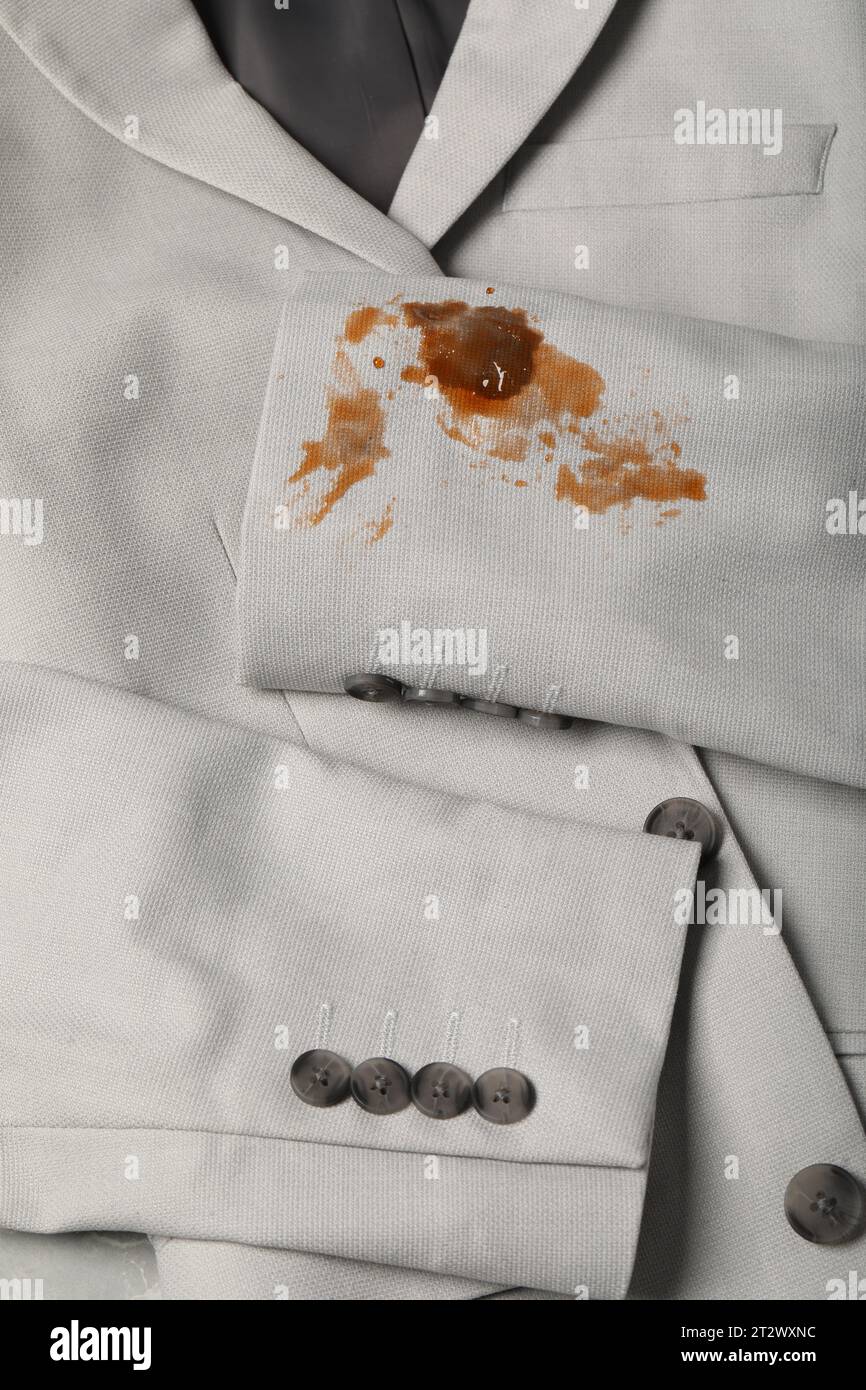 Dirty jacket with stain of coffee on light grey surface, top view Stock ...