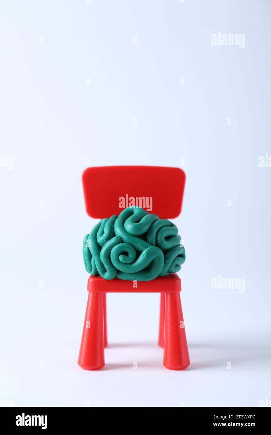 Brain made of plasticine on mini chair against white background Stock ...