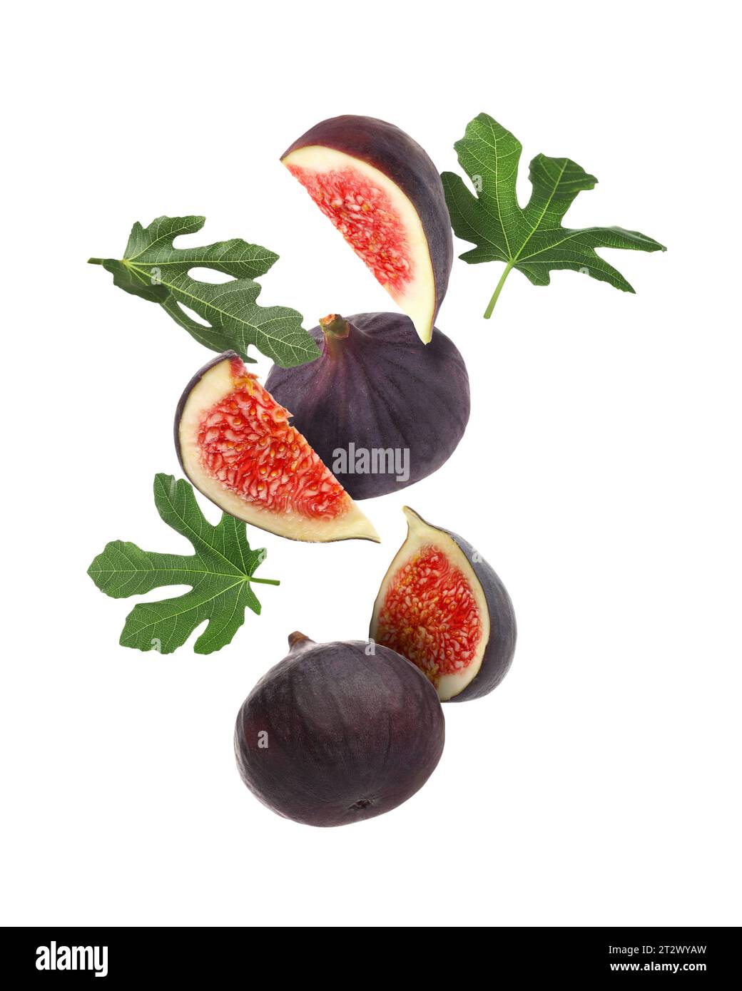 Fresh figs and green leaves falling on white background Stock Photo - Alamy