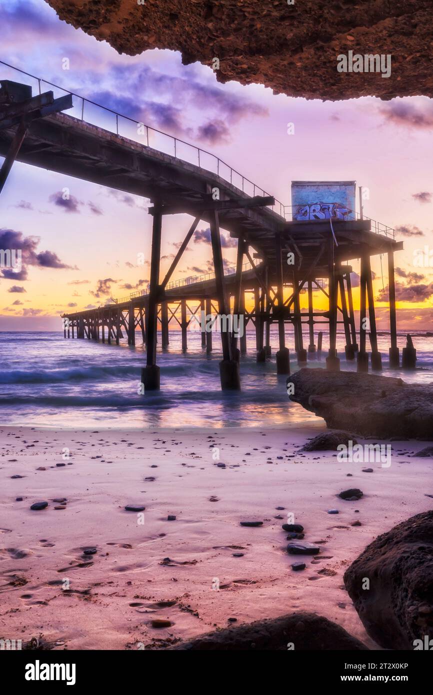 Historic timber Catherine Hill bay jetty by sea caves on Middle Camp ...