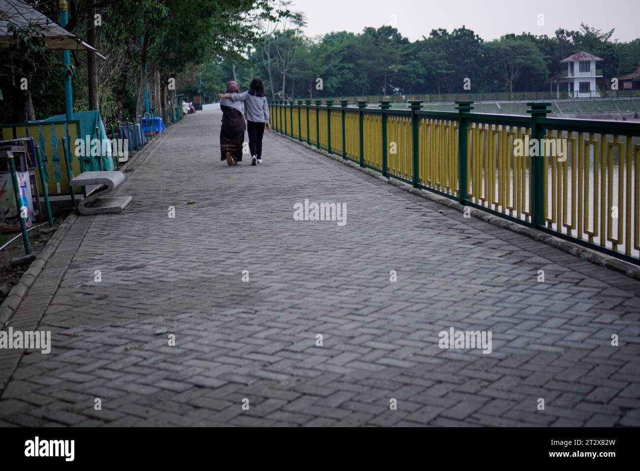 two women who were walking enjoying the park in the afternoon. seen ...