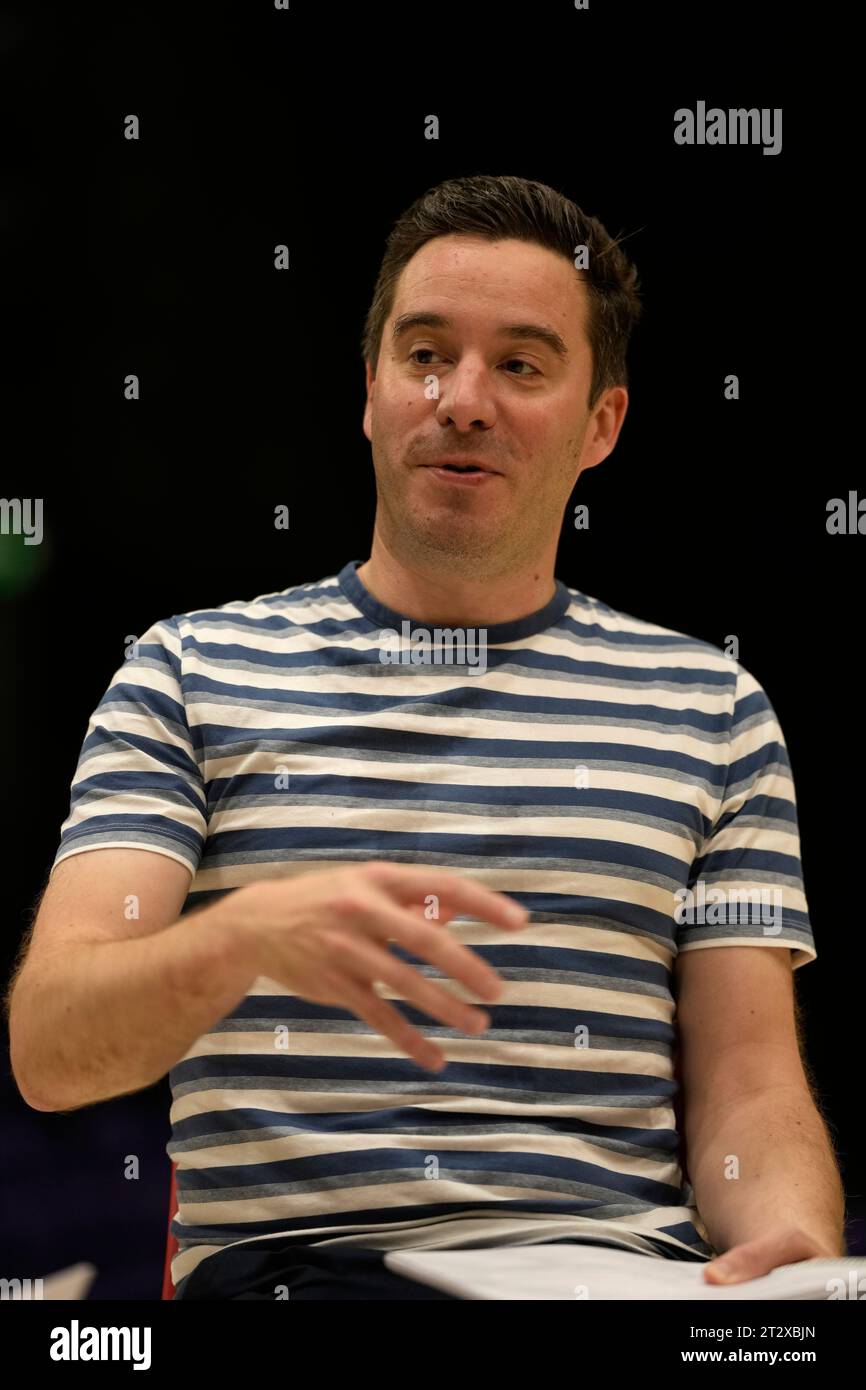 Writer James Graham speaks to actor Joseph Fiennes, on stage as they ...