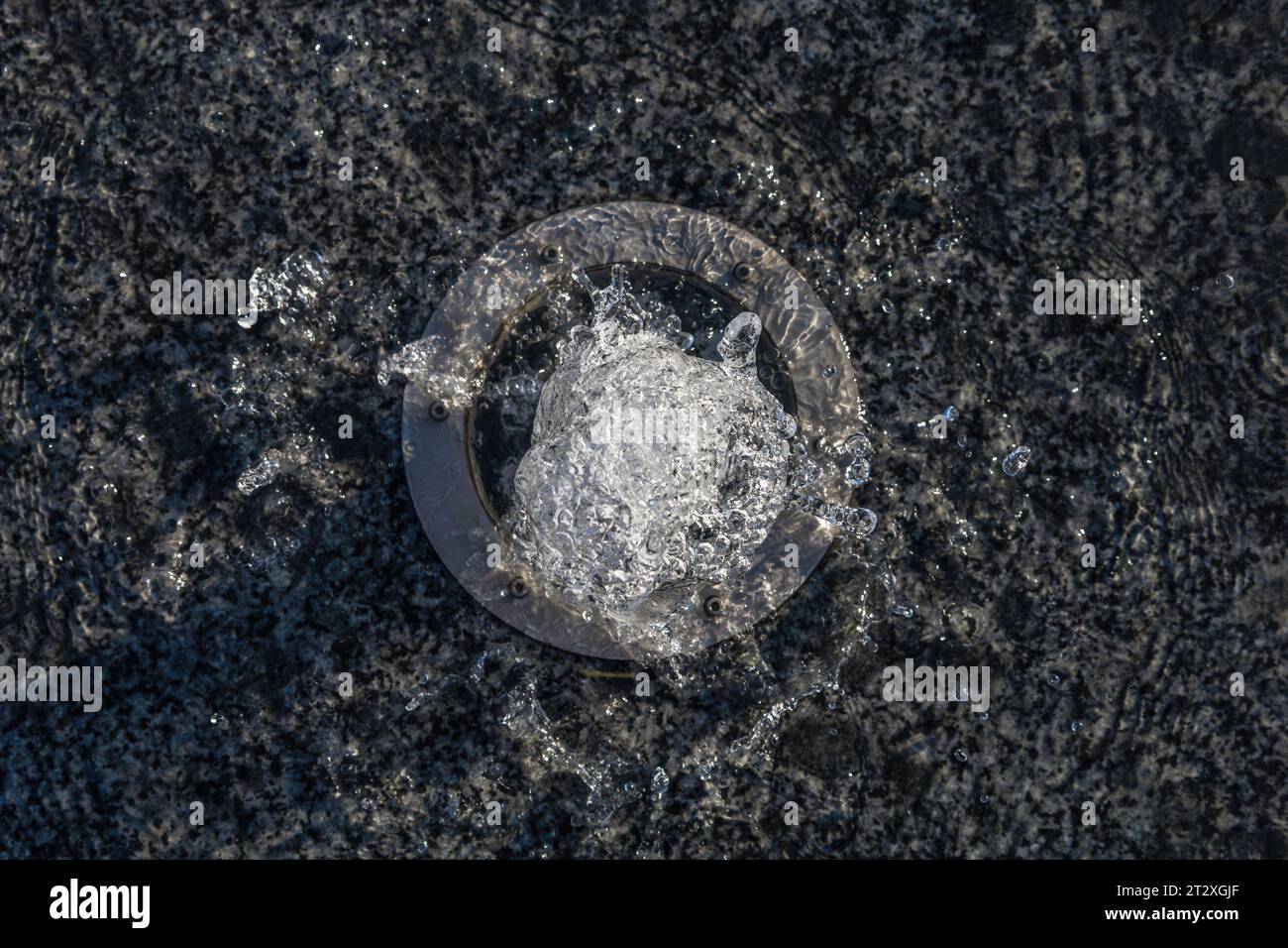 Water splash at the location in the park with a mini fountain located ...
