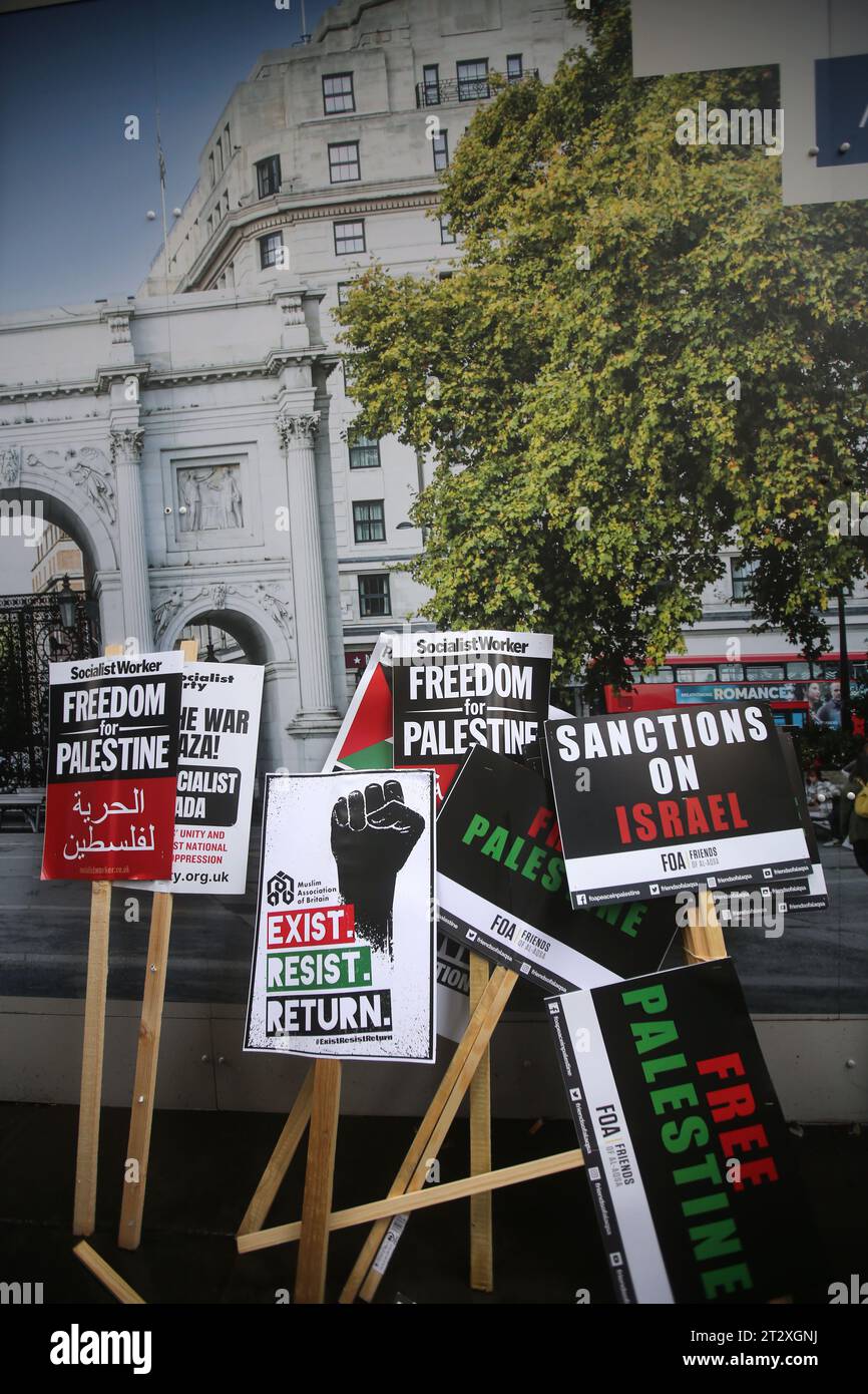 Pro Palestinian signs are rested against a billboard showing a ...