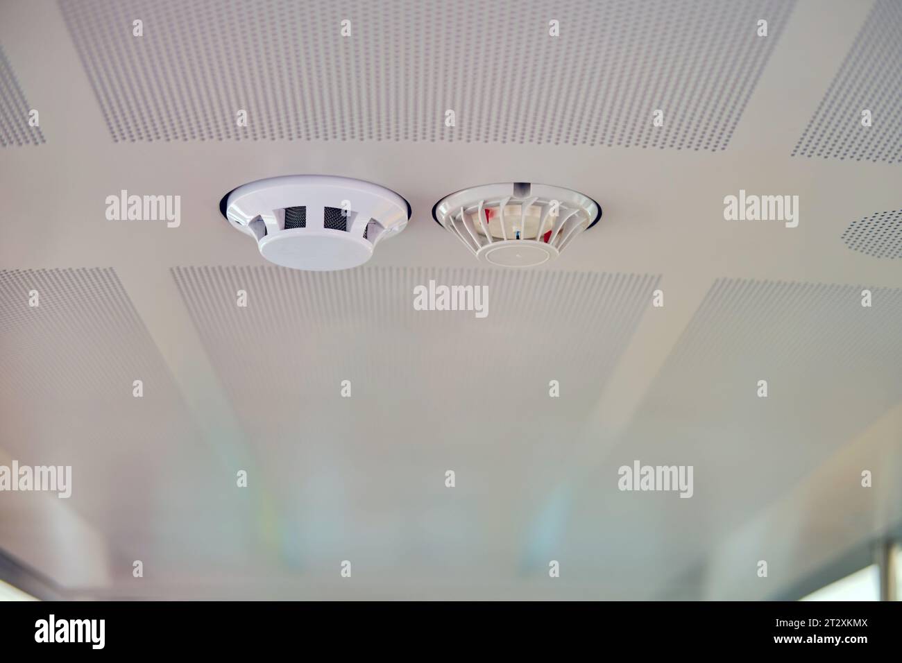 Fire alarm or fire sprinkler on ceiling in transport, security concept ...
