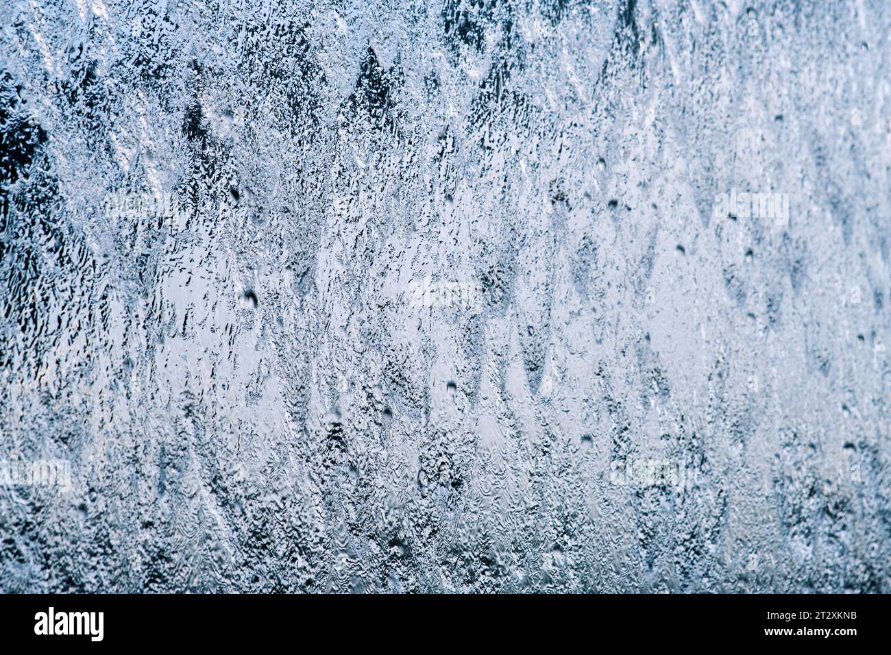 Water jets on a glass waterfall flow down creating a beautiful ...