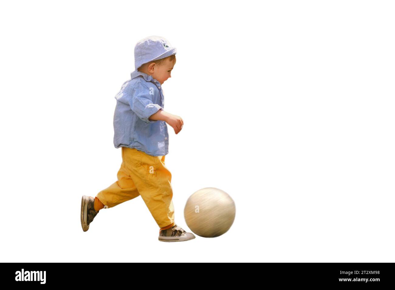 The child is having fun kicking the soccer ball around on the outdoor ...