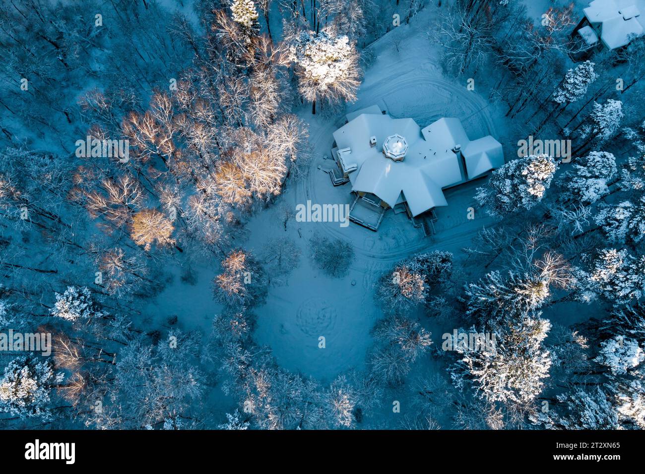 Aerial view of an old manor house hidden among a fabulous snow-covered ...