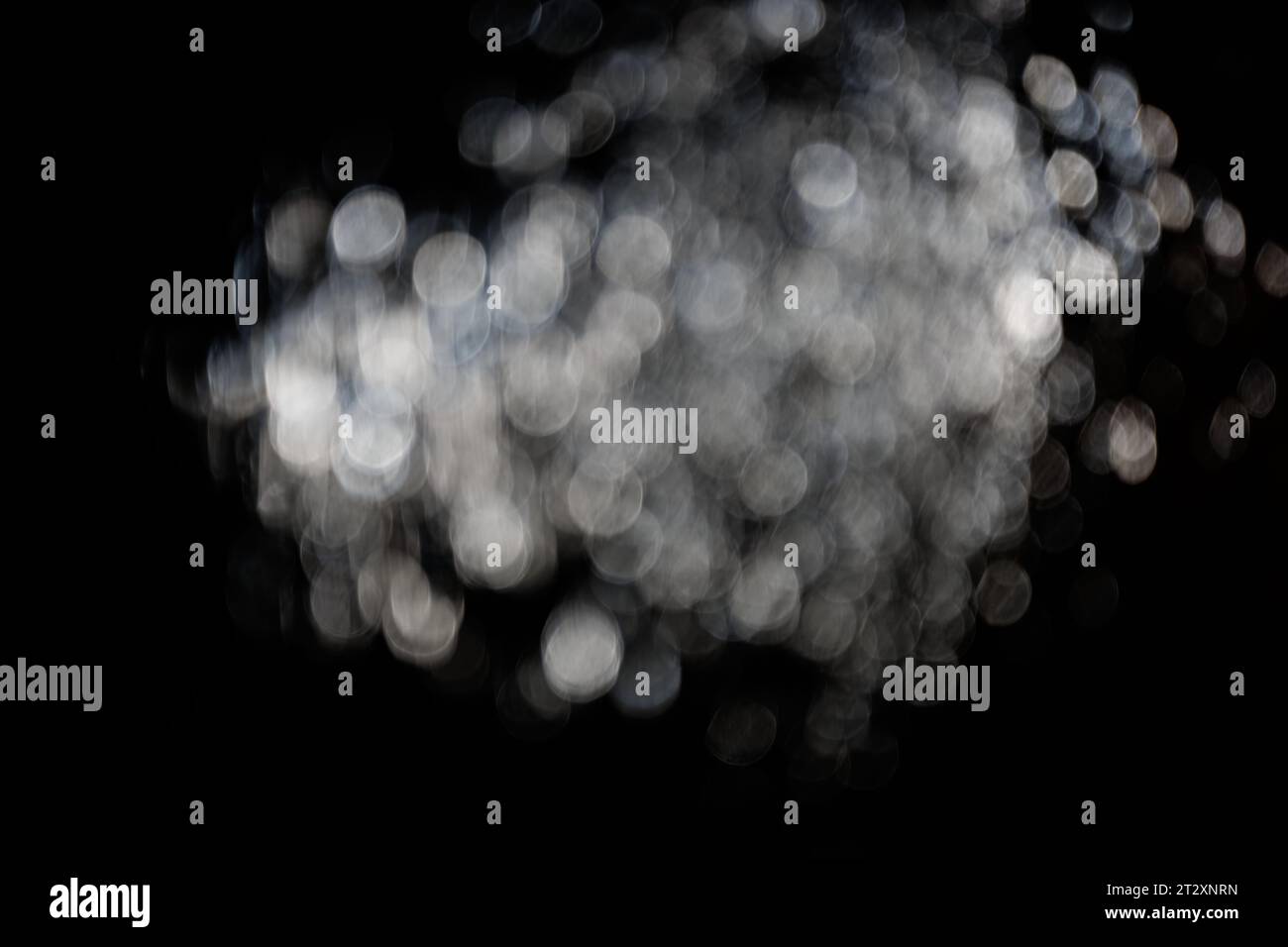 Blurred bokeh with sparkling water glitter with cool mist flash effect ...