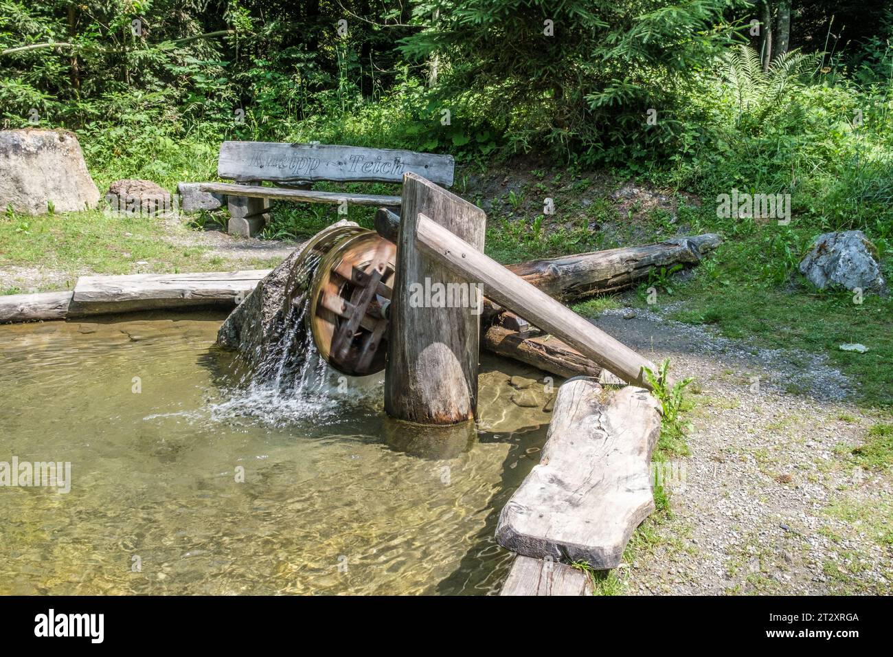 Rustic wooden water wheel spinning in the pond along the Path of ...