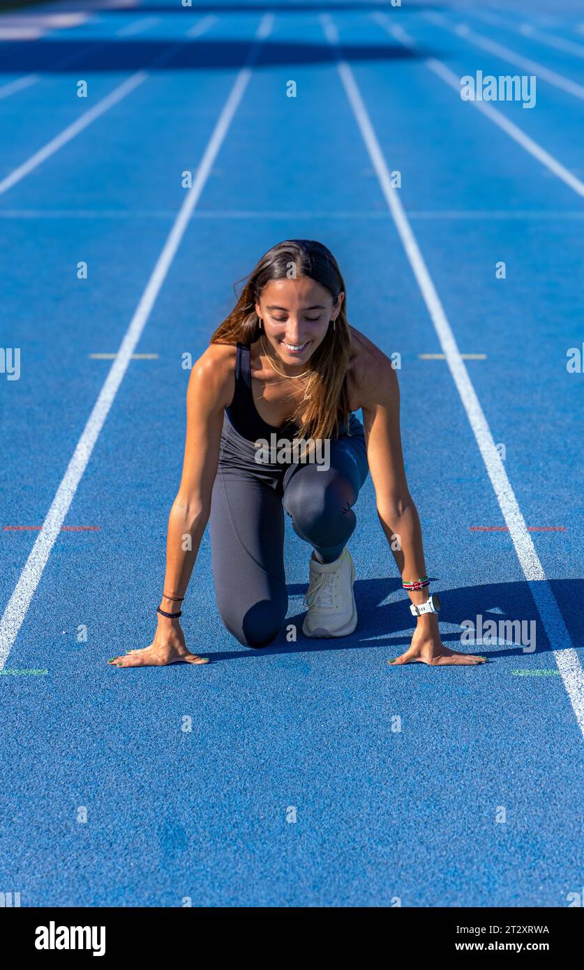 Beautiful young runner girl, tanned with long dark hair, smiling ...