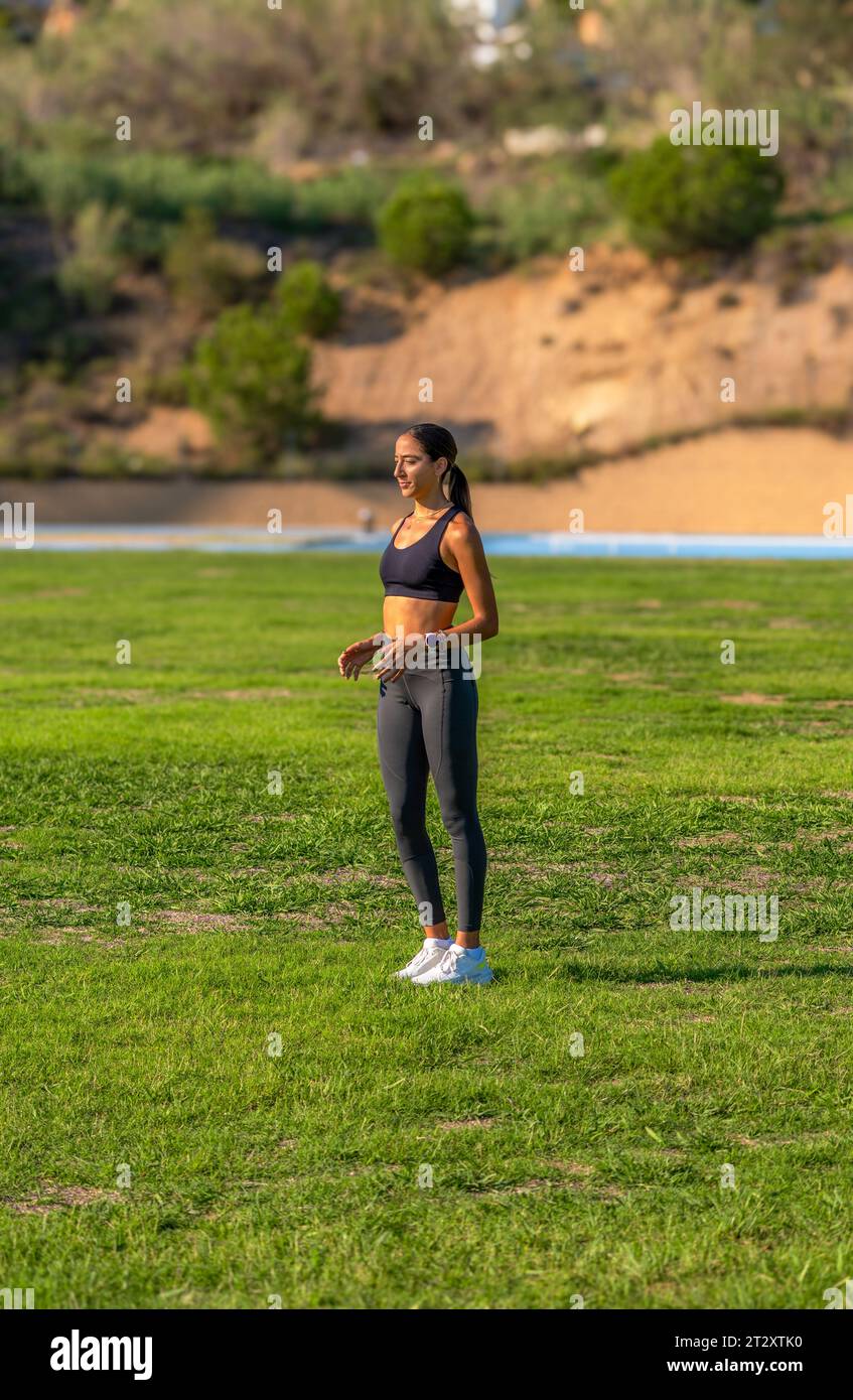 Beautiful young slim runner girl, dressed in tight sportswear ...