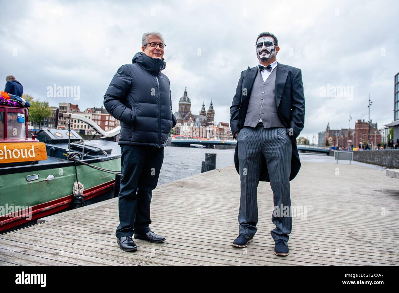 A man dressed as a Catrin (male skeleton) is seen talking to another ...