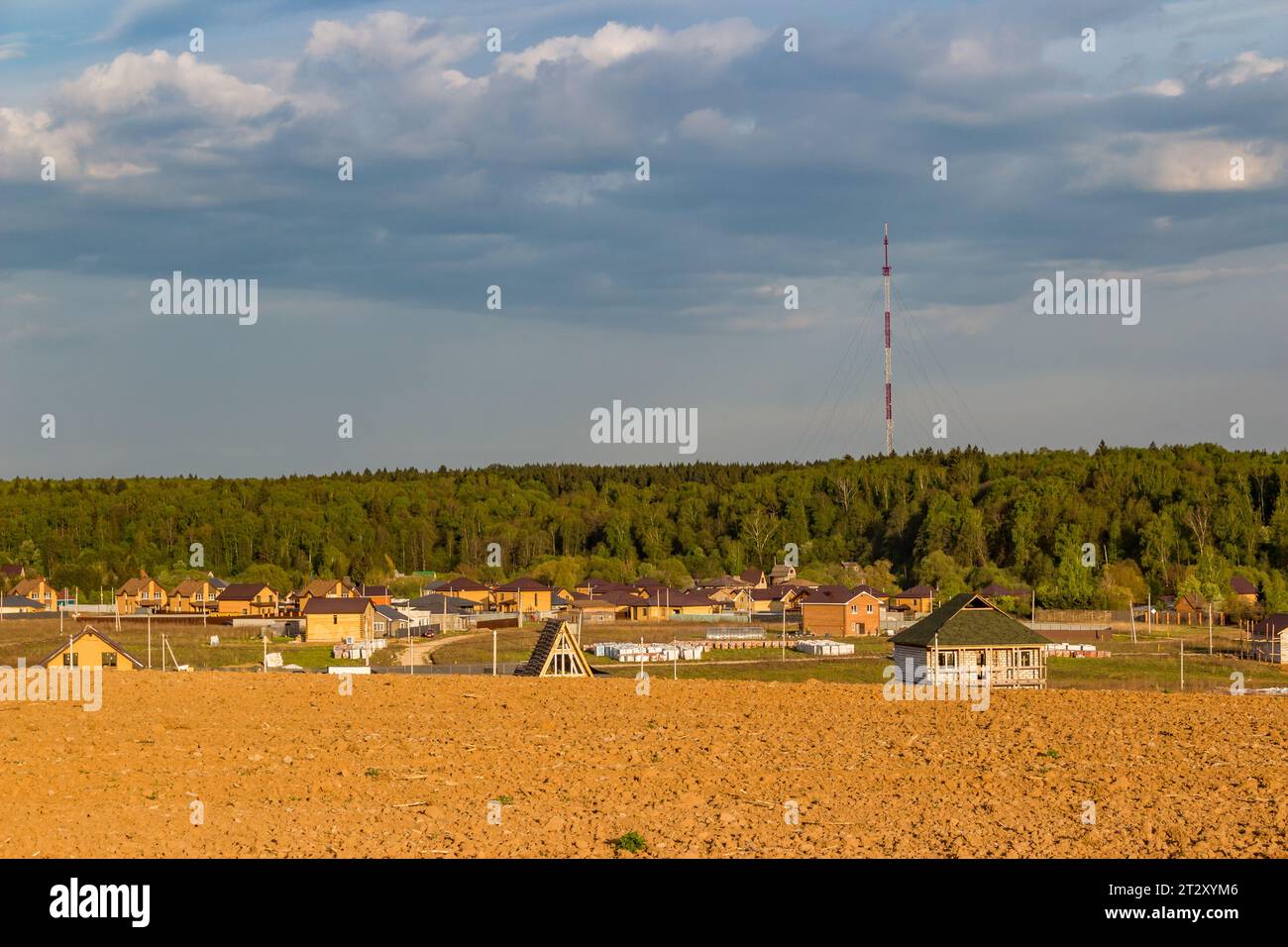 A distant view of a village under construction with similar houses in ...