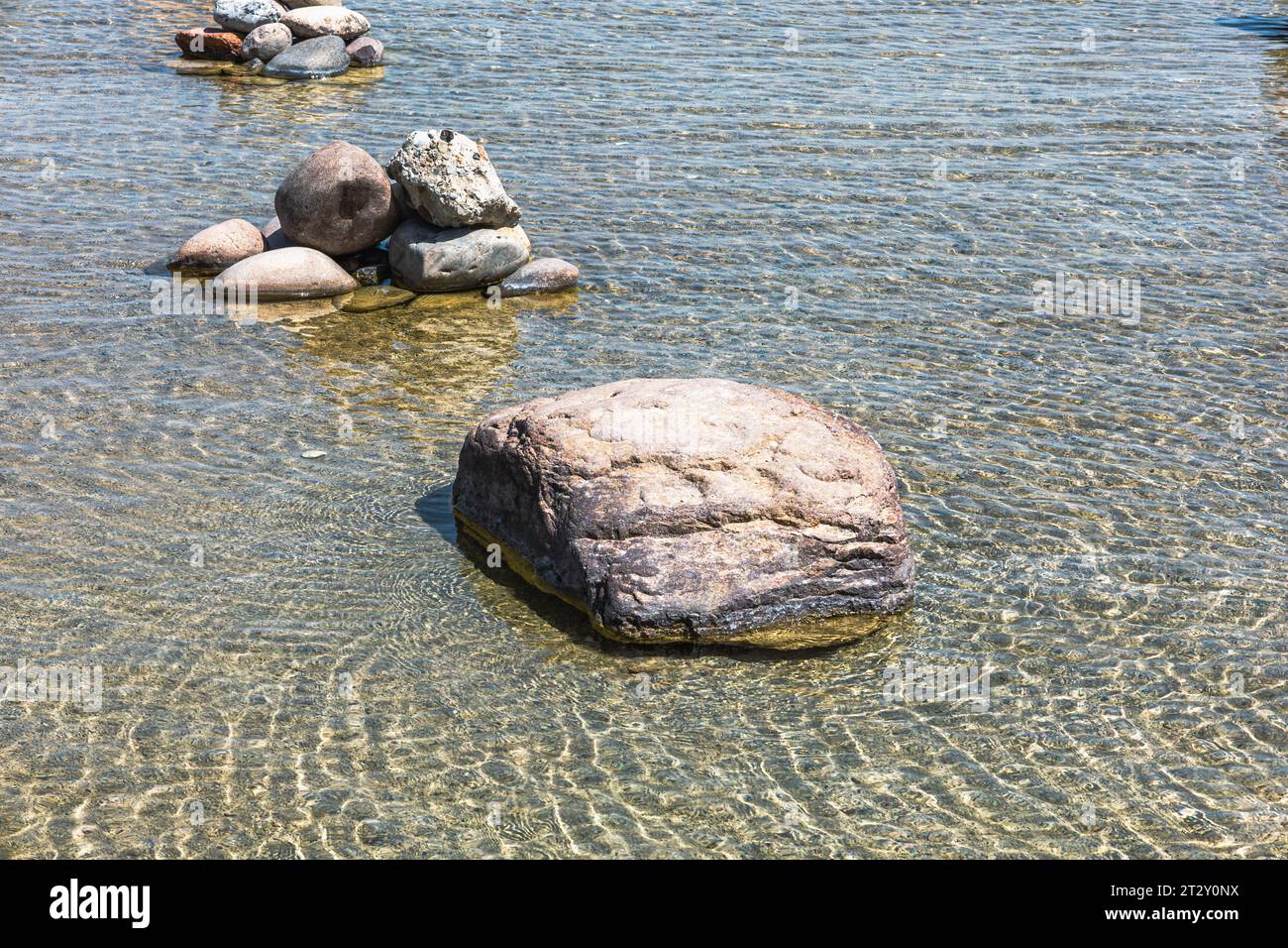 Background sea water near the shore with a stone shore Stock Photo - Alamy