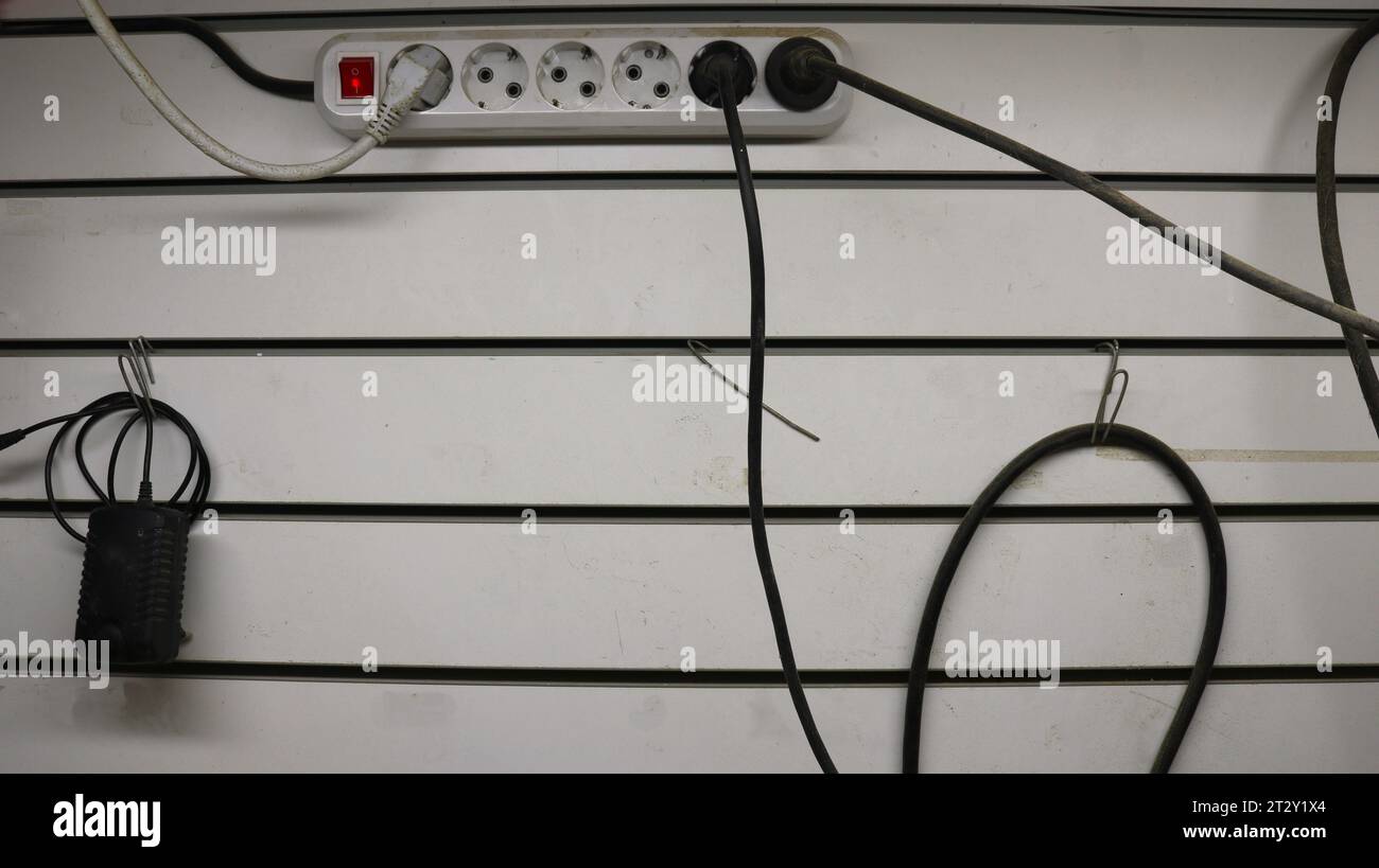 background of a wall made of white horizontal panels with sockets and ...