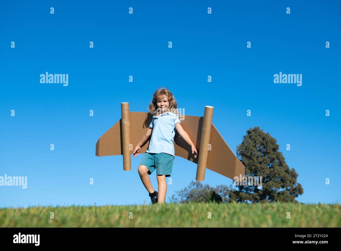 Little child plays astronaut or pilot. Child on the background of blue ...