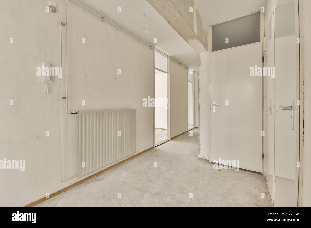 an empty room with white walls and no one person standing in the ...