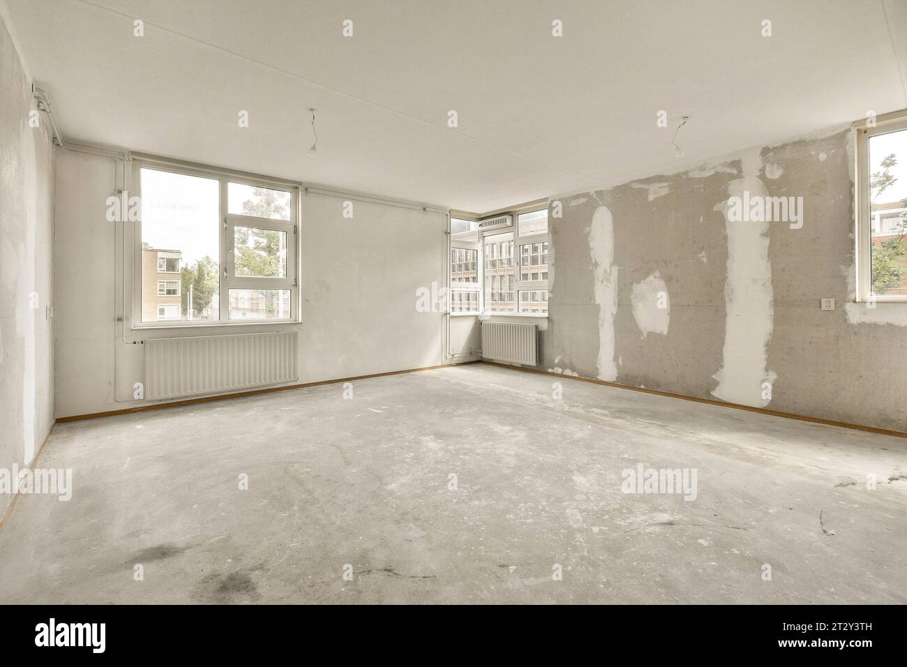 an empty room with white walls and dry plaster all over the floor ...