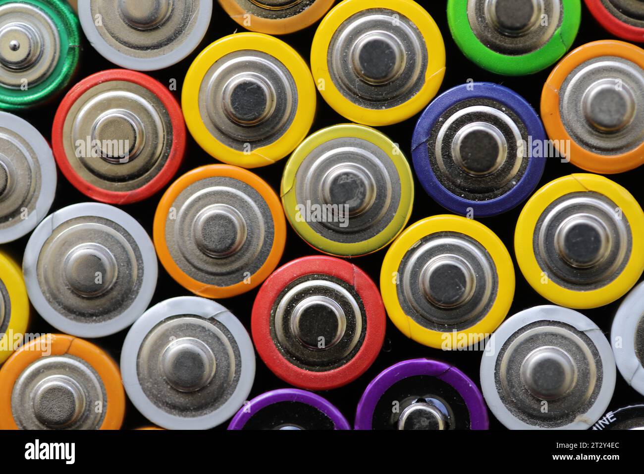 many round batteries and one red battery Stock Photo - Alamy