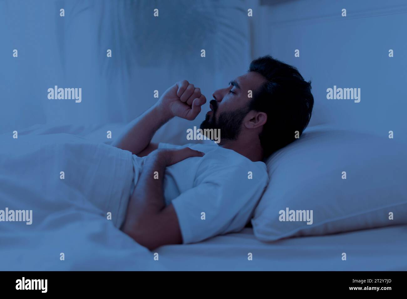 Side View Of Sick Indian Man Coughing In Bed In The Night Stock Photo ...