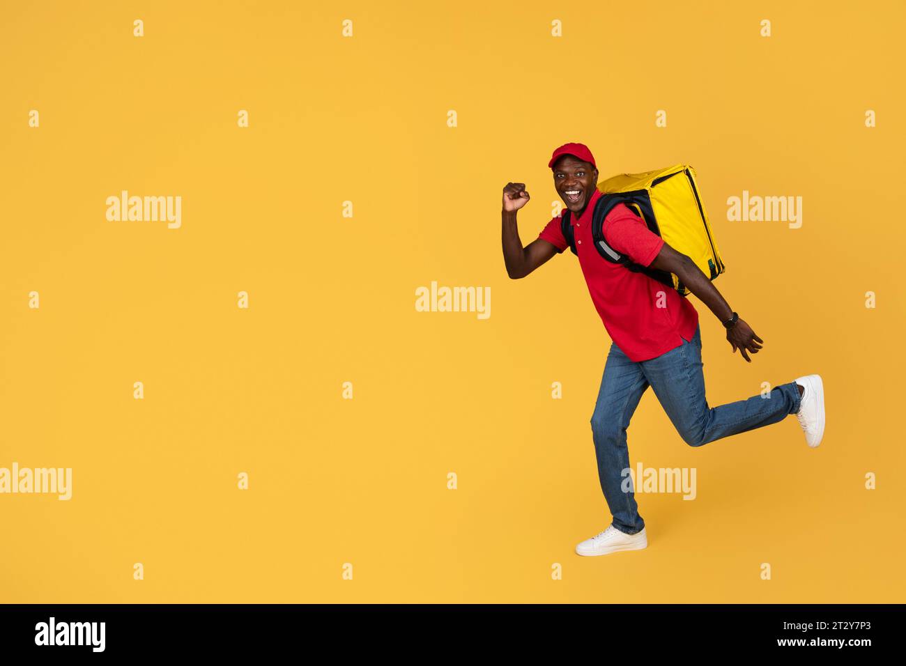 Glad funny young black delivery man in uniform and cap with big ...