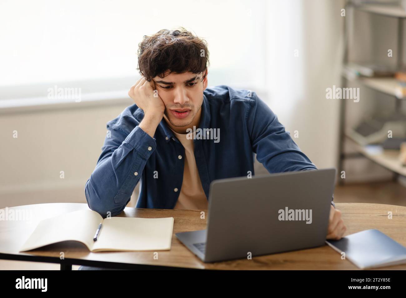 Unhappy overworked arabian businessman sitting sad at workplace Stock ...