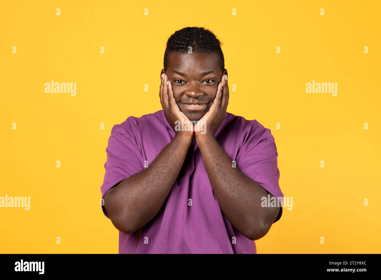 Contented Smiling Black Man Cupping Face In Hands, Yellow Background ...