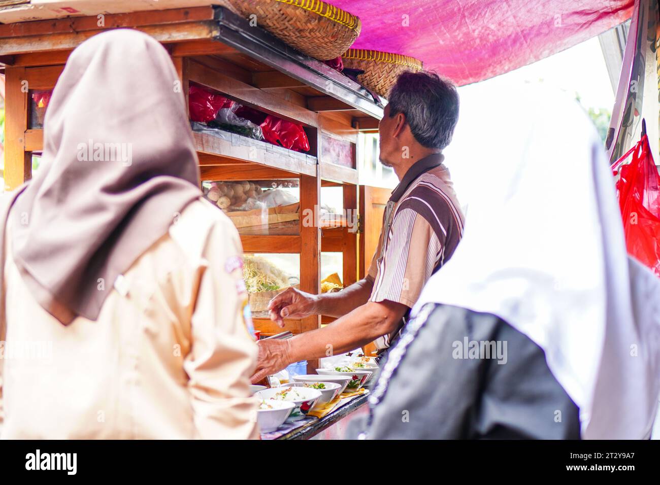 Busy street food scene: successful meatball vendor fulfilling orders ...