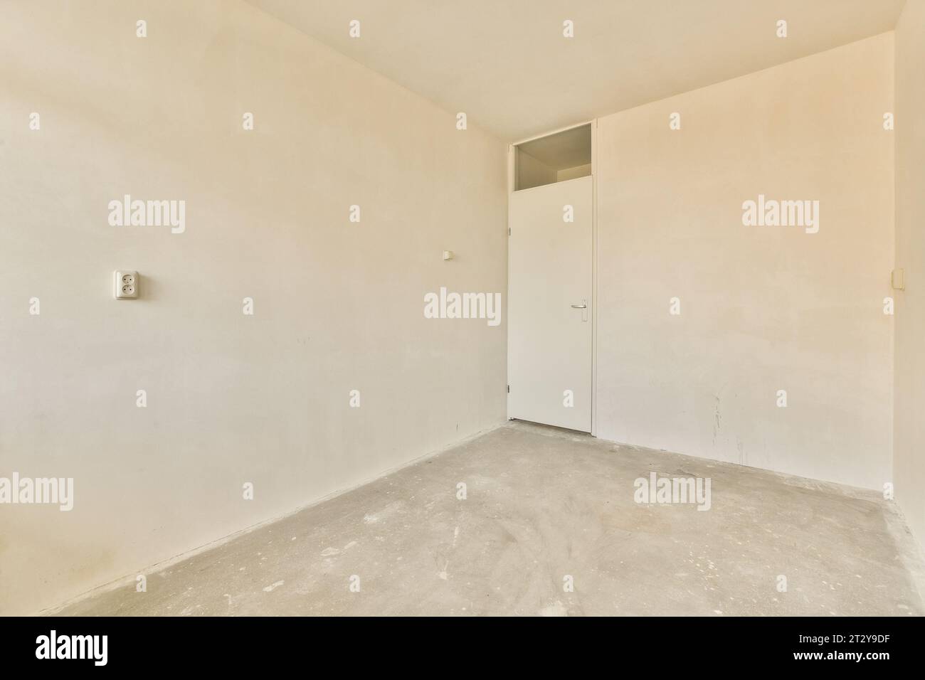 an empty room with white walls and no one door on the other wall there ...
